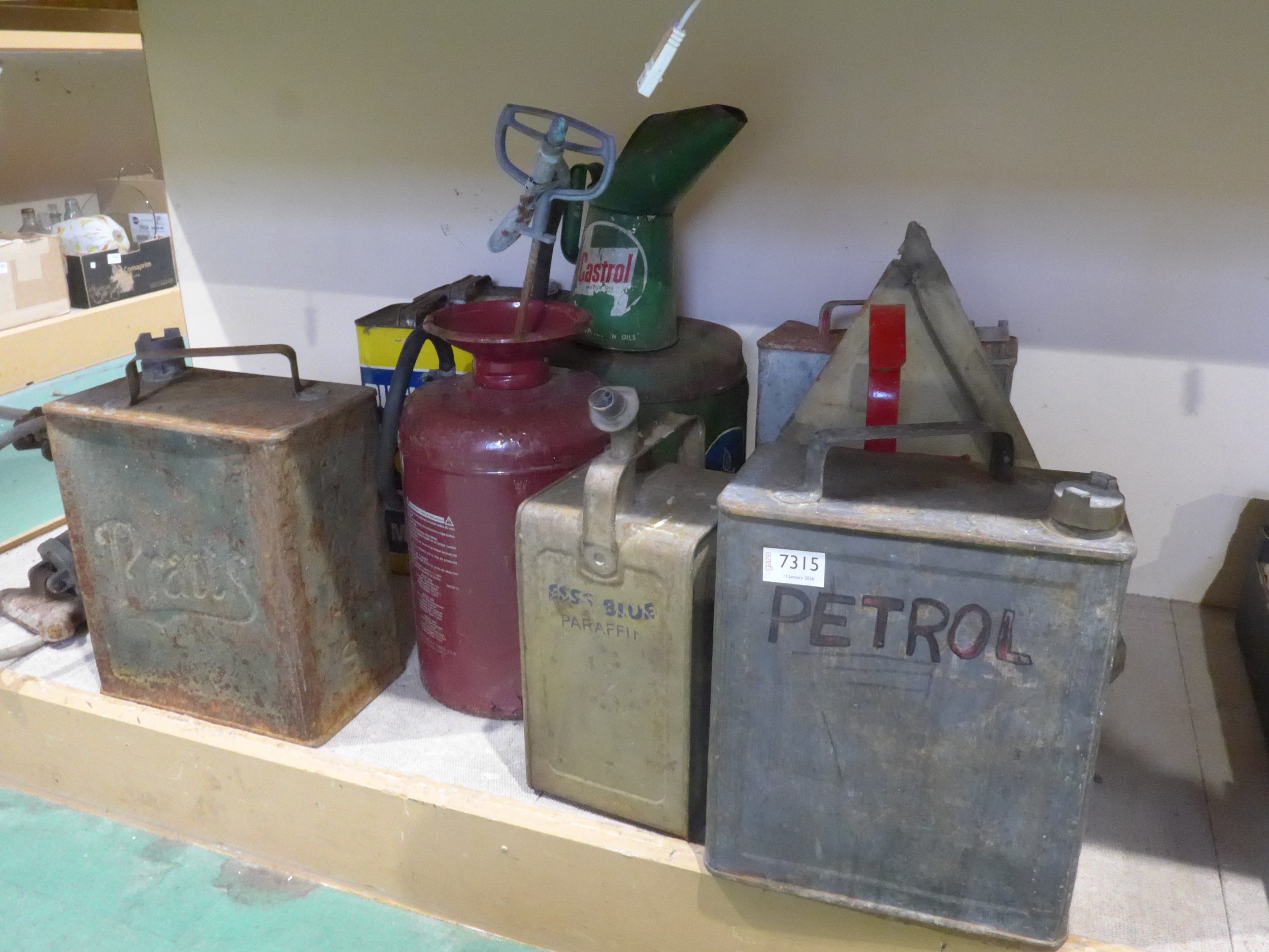 A quantity of oil/petrol cans, pump, lamp, warning triangle etc