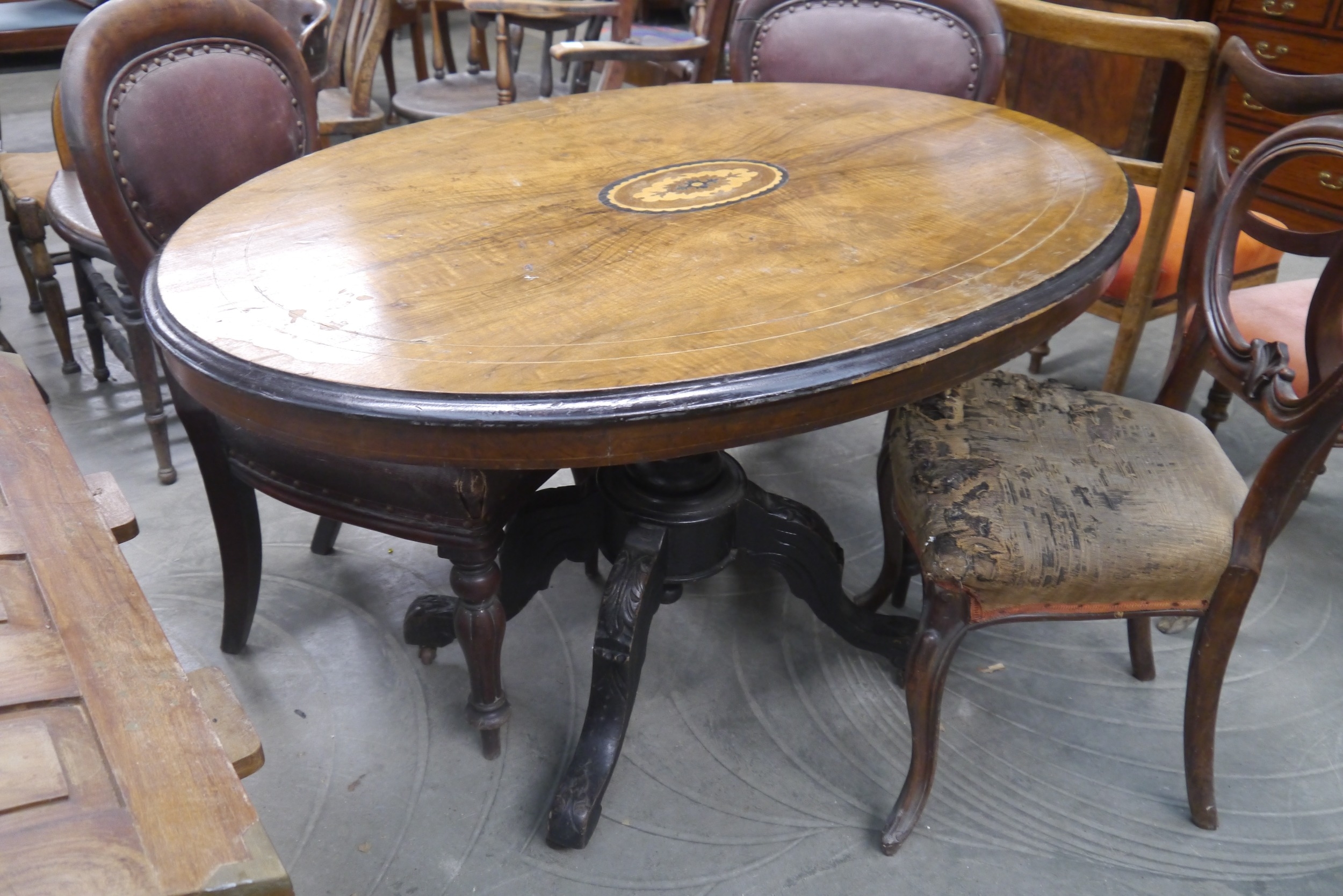 A Victorian figured walnut inlaid loo table