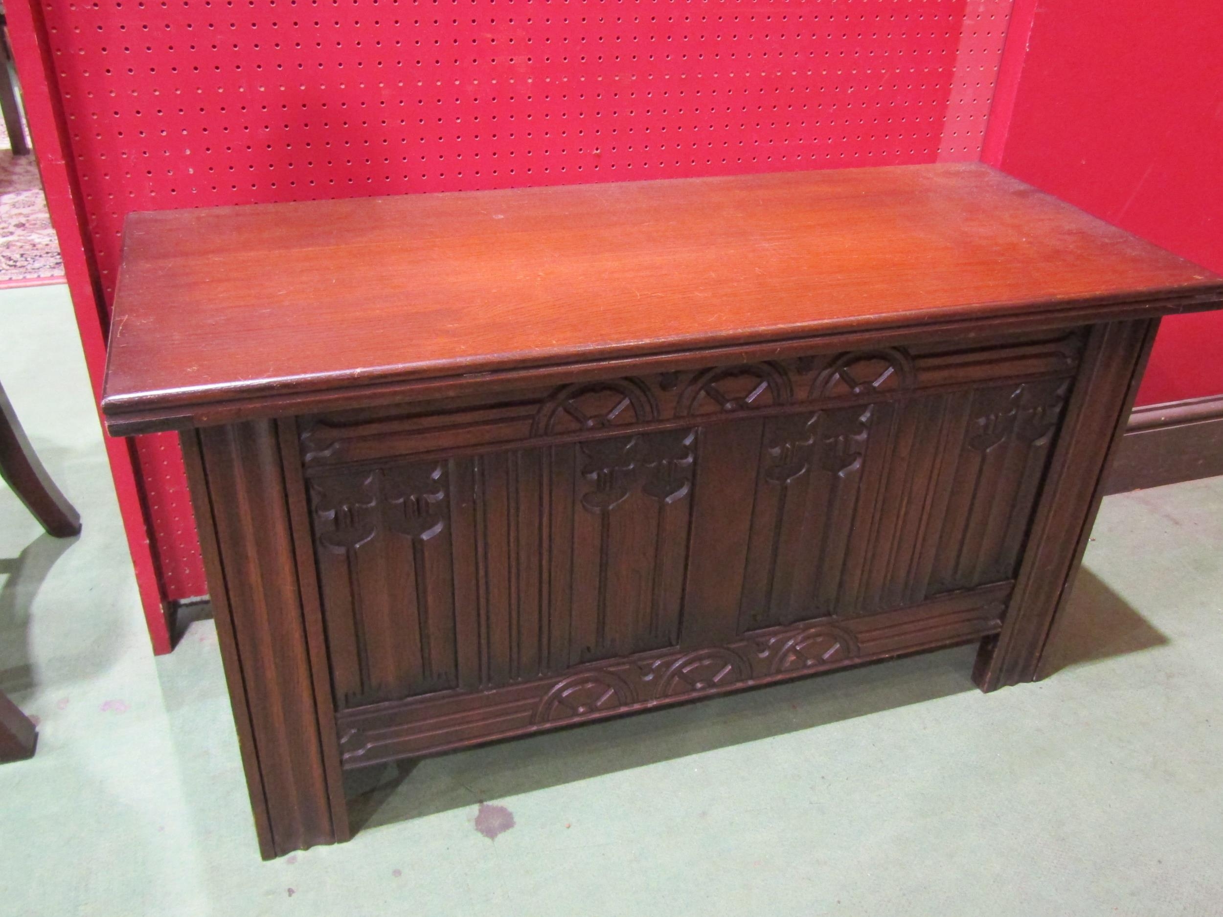 An oak 18th Century style linen fold panel coffer, the hinged lid over ...