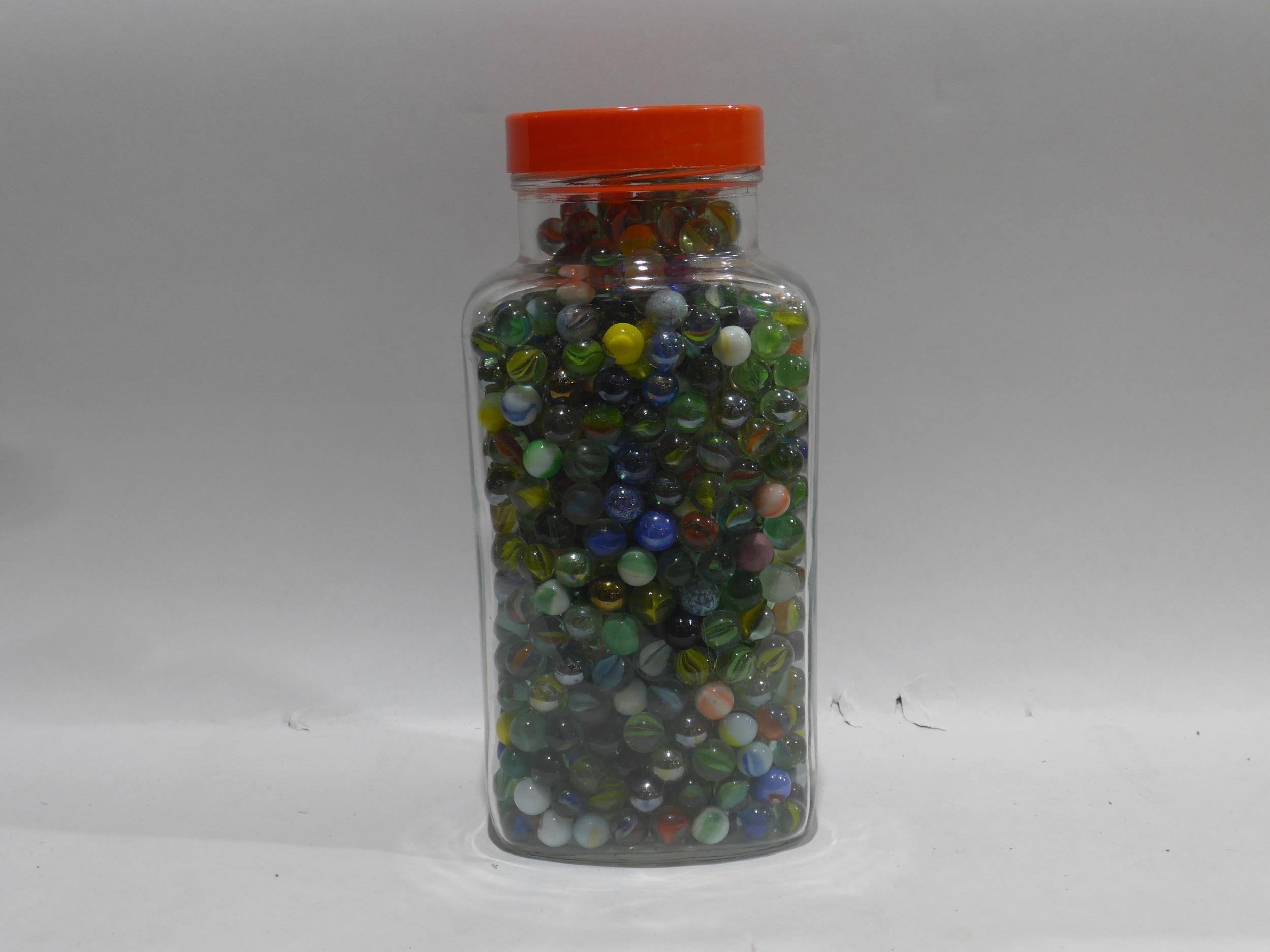 A sweet jar containing a quantity of marbles