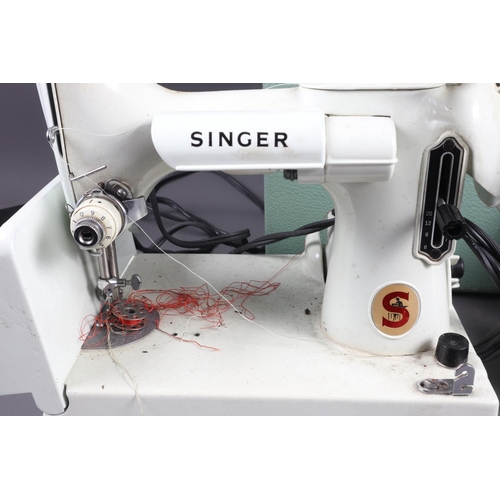 An electrical portable Singer sewing machine, model 221K, in case, with ...