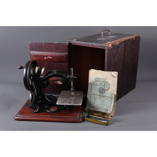 A Wilcox & Gibbs sewing machine, in box with original paperwork