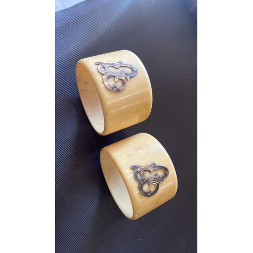 TWO NAPKIN RINGS WITH SILVER DETAIL