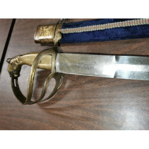 Indian, brass lions head handle sword in scabbard