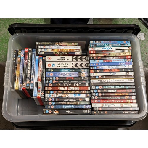 Plastic storage tray with lid full of assorted DVDs