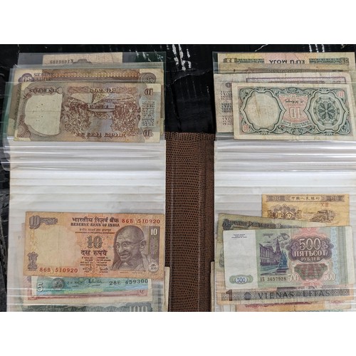 Brown folder with 40 x assorted foreign bank notes