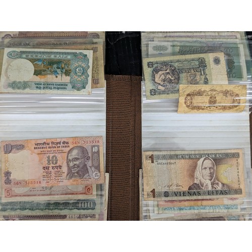 Brown folder with 40 x assorted foreign bank notes