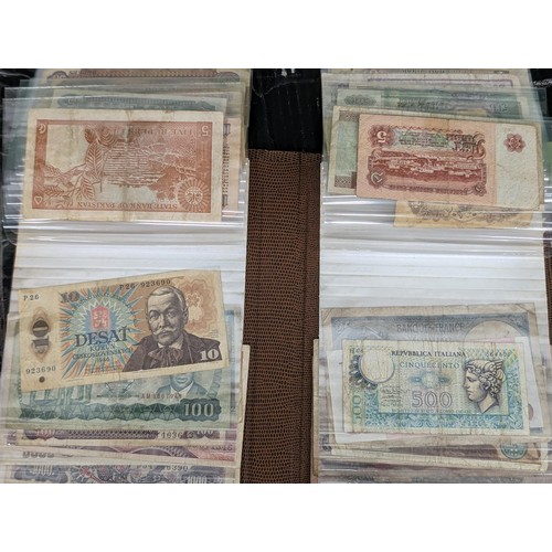 Brown folder with 40 x assorted foreign bank notes
