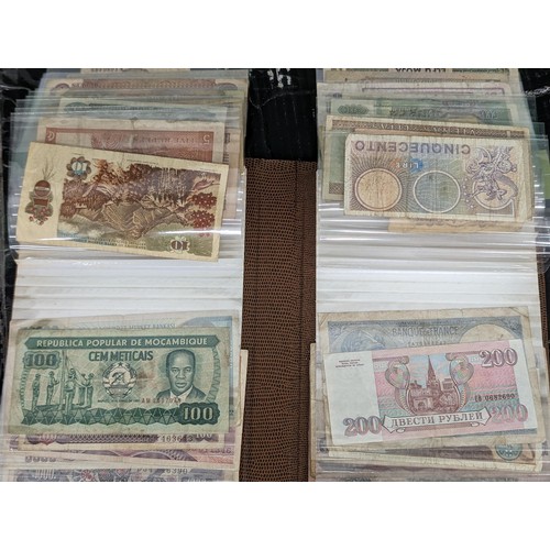 Brown folder with 40 x assorted foreign bank notes