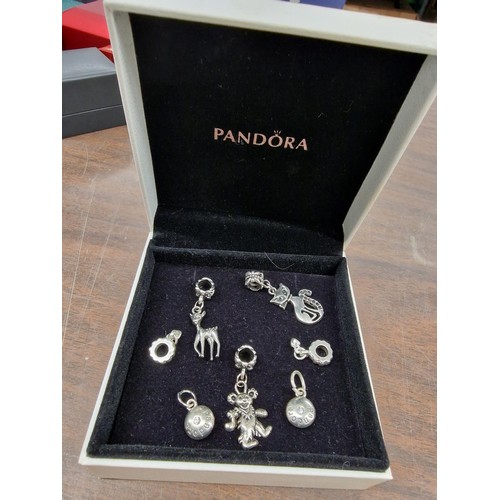 Pandora box containing 7 x dangling charms, 2 stamped as Pandora but ...