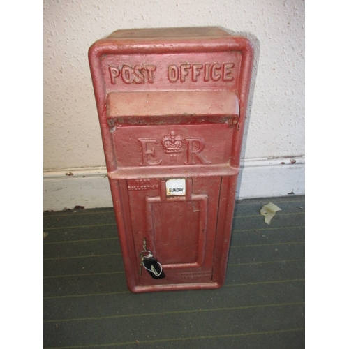 A vintage steel post box, with later ground post, faded colour but with ...