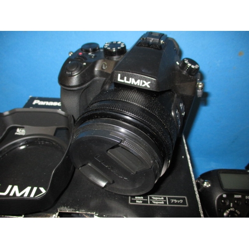 Three pre-owned cameras with lenses, to include Nikon F5 and a Lumix ...