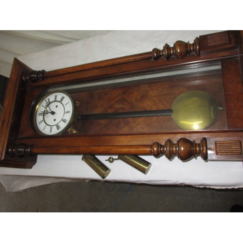 A vintage mahogany cased wall clock, with key and pendulum, in used ...