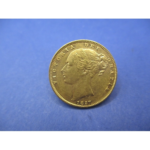 A Victorian gold sovereign dated 1857, a circulated coin with fine ...