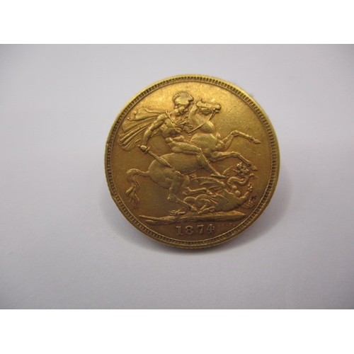 A Victorian gold sovereign dated 1874, a circulated coin with fine ...