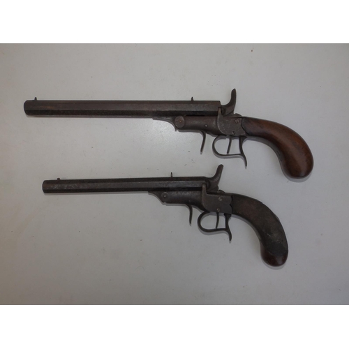 Two percussion lock pistols with octagonal barrels, one with chequered ...