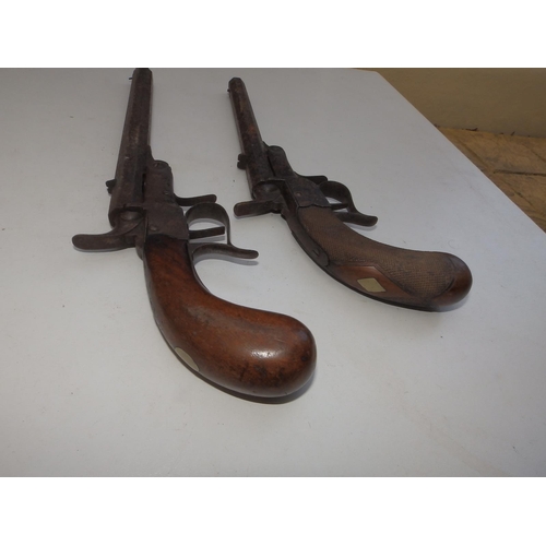 Two percussion lock pistols with octagonal barrels, one with chequered ...