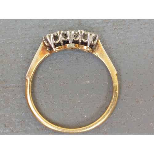 A three stone diamond ring in PLAT & 18ct. Finger size M.