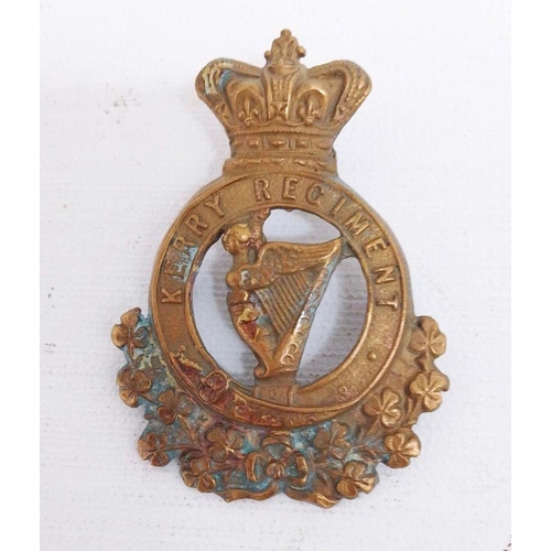A BRASS KERRY REGIMENT CAP BADGE, reading ‘Kerry Regiment’ with ...