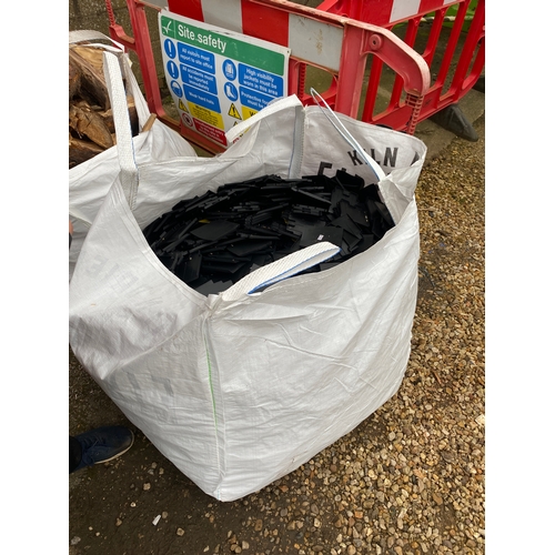 Very large builders bag full of thousands of plastic scrapers