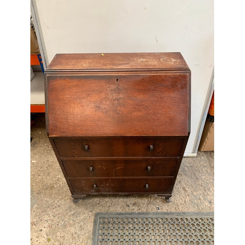 Dark wood writing bureau with drawers