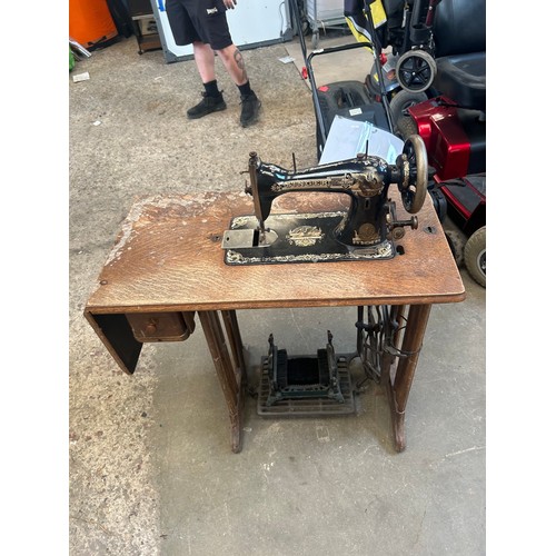 Singer sewing machine on original stand base