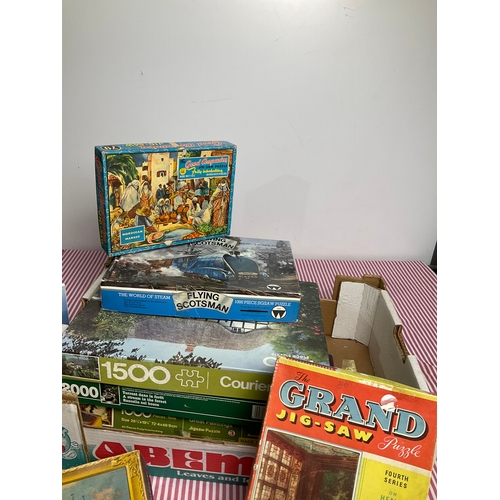 Collection of jigsaw puzzles including vintage