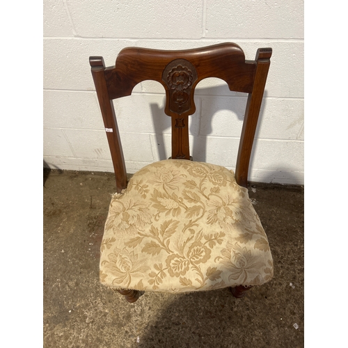 Antique wooden hardwood dark-stained chair with floral cream upholstery