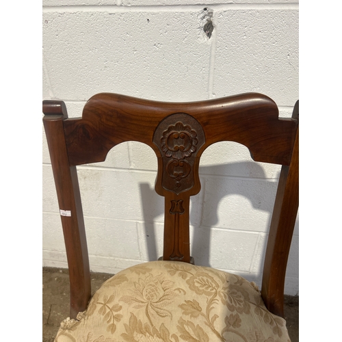 Antique wooden hardwood dark-stained chair with floral cream upholstery