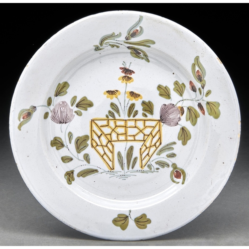 A Liverpool Delftware plate, c1760, painted in the Fazackerley palette ...