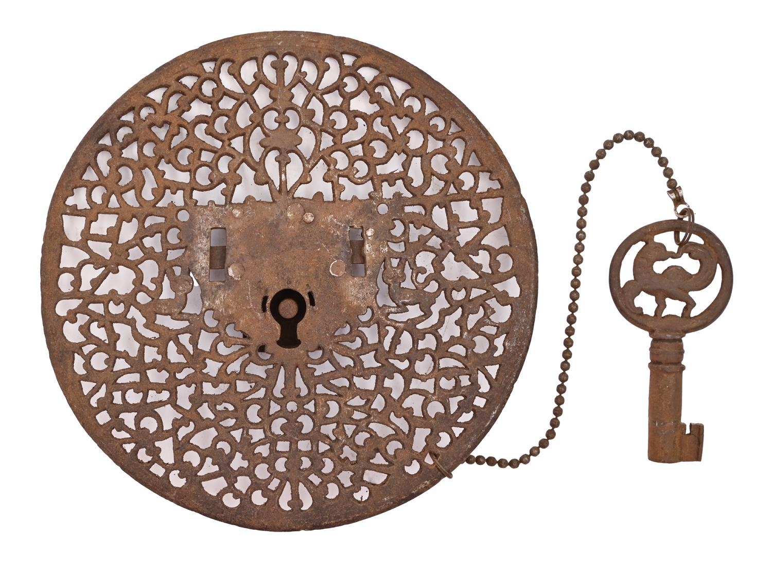 A Continental round pierced steel trunk lock and key, 18th c, the ...