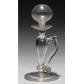 A glass open flame oil lamp, late 18th c, on folded foot, soda metal ...