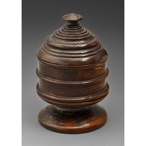 Treen. An oak mortar and cover, 17th c, turned with reeds, the stepped ...