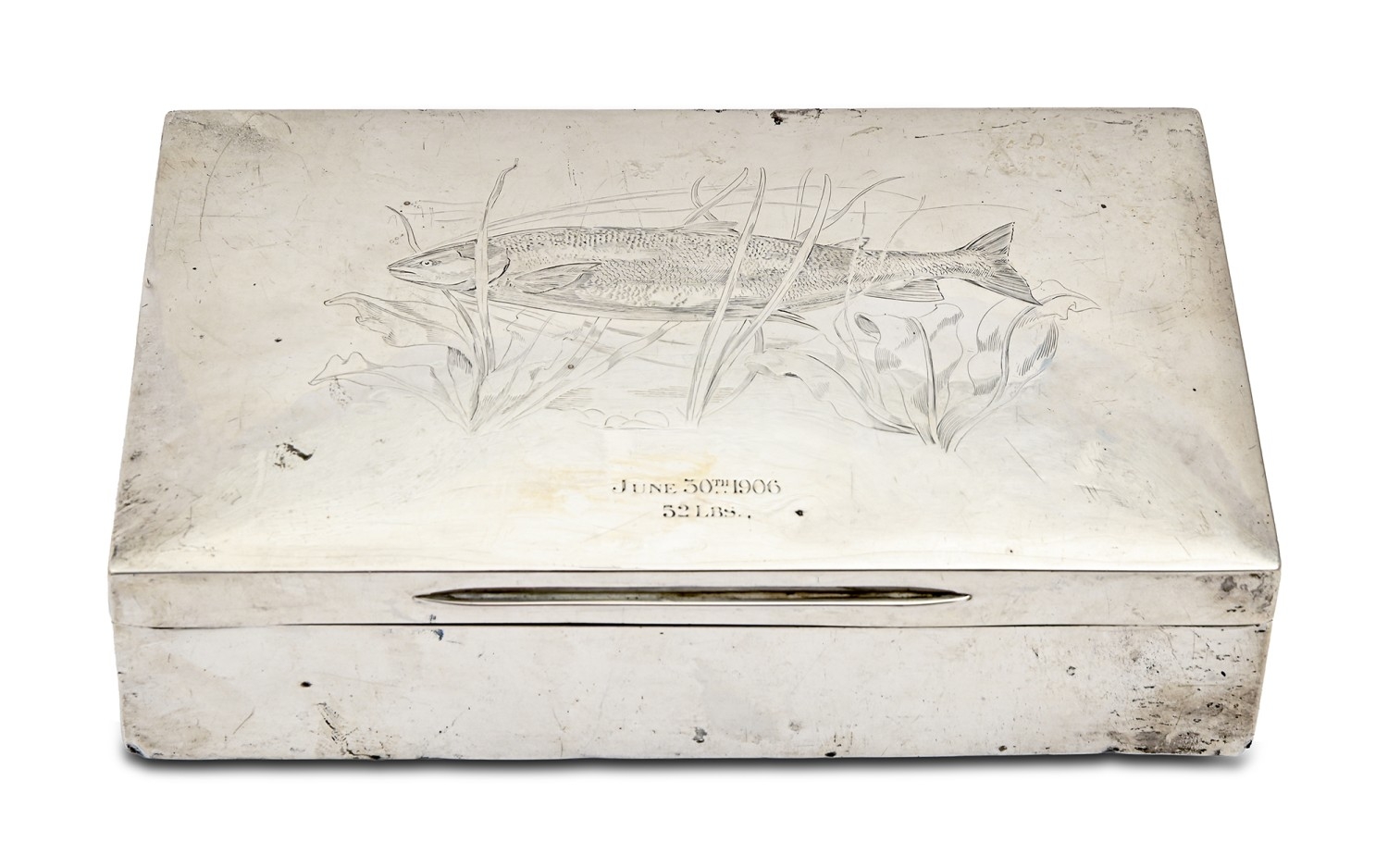 An Edwardian silver cigar box, the lid engraved with a fish amidst ...