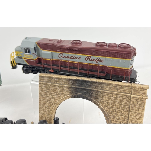 A box of assorted model railway locos, coaches, parts and accessories ...