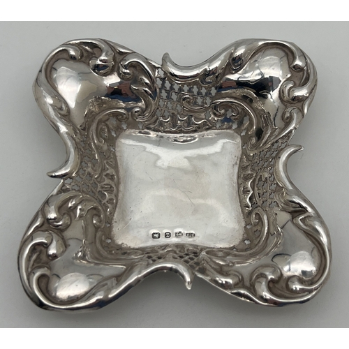 A late Victorian silver square shaped pin dish with decorative scroll ...