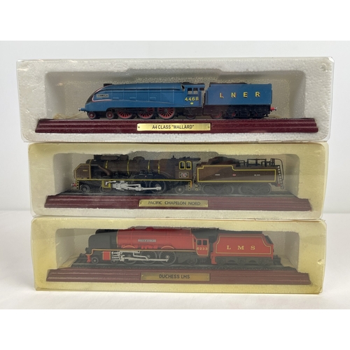 3 boxed Atlas Editions model trains on wooden plinths, each approx ...