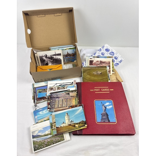 A vintage postcard album of coloured postcards together with a box of ...