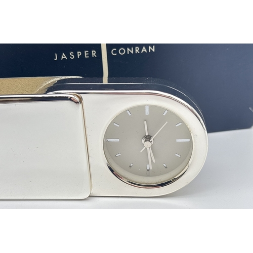 A boxed Jasper Conran silver plated folding travel alarm clock. Oval ...