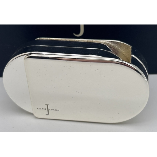 A boxed Jasper Conran silver plated folding travel alarm clock. Oval ...