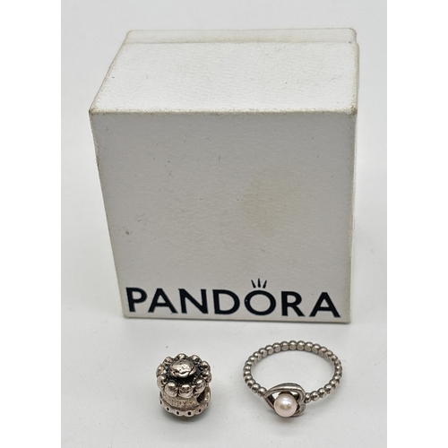 A boxed Pandora birthday cake charm together with a silver bubble ...