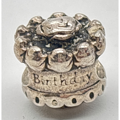 A boxed Pandora birthday cake charm together with a silver bubble ...