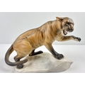 A large Beswick ceramic model of a Puma on a rock, model #1702 in tawny ...