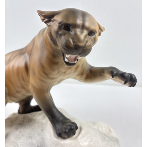 A large Beswick ceramic model of a Puma on a rock, model #1702 in tawny ...
