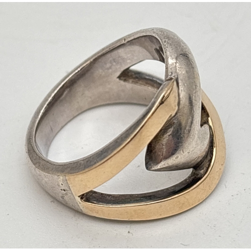 A modern entwined design band ring in silver and silver gilt finish ...