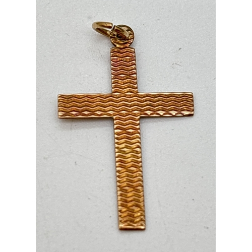 A vintage 9ct gold cross pendant with engine turned wave decoration to ...