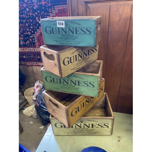 Five graduated Guinness advertising boxes