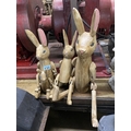 Four graduated wooden jointed rabbits