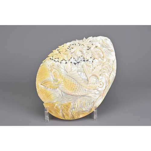 A LARGE CARVED MOTHER OF PEARL SHELL, PROBABLY JAPANESE EARLY 20TH ...