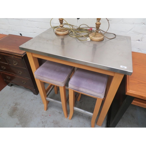 Metal topped table with a pair of matching stools